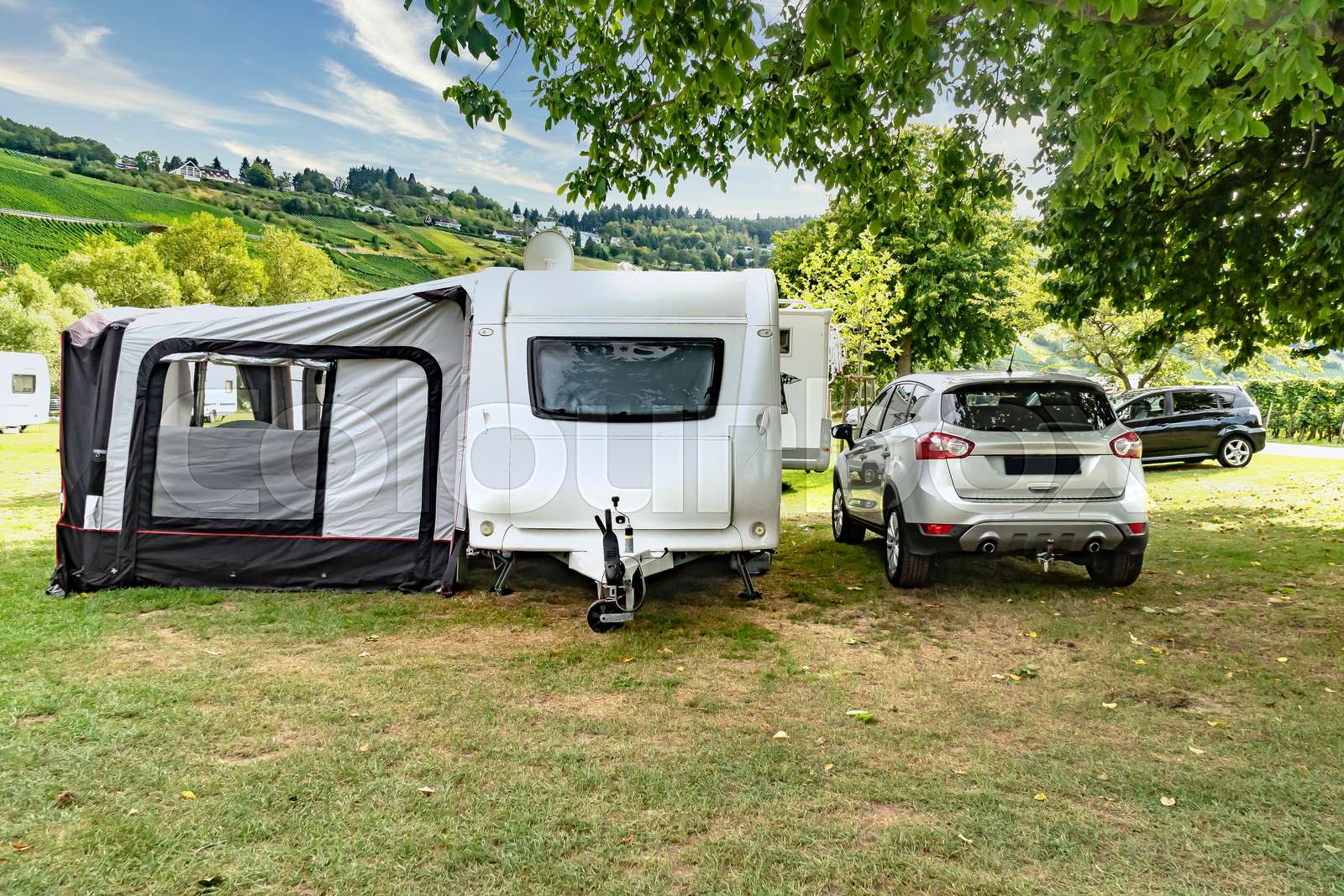 Caravan with car on campsite | Stock image | Colourbox
