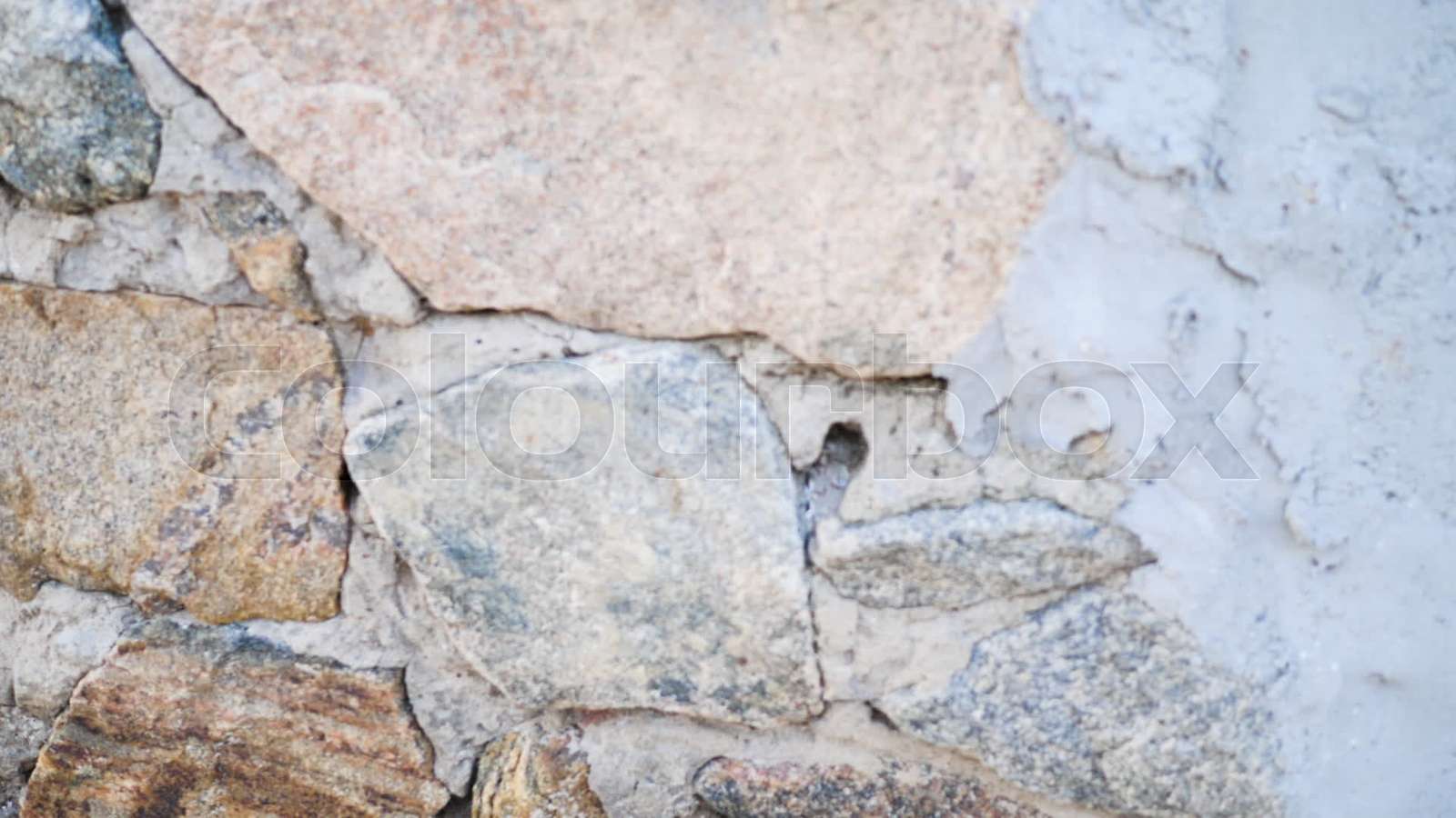 Texture of old stones of various forms with seams. Close up of shabby ...