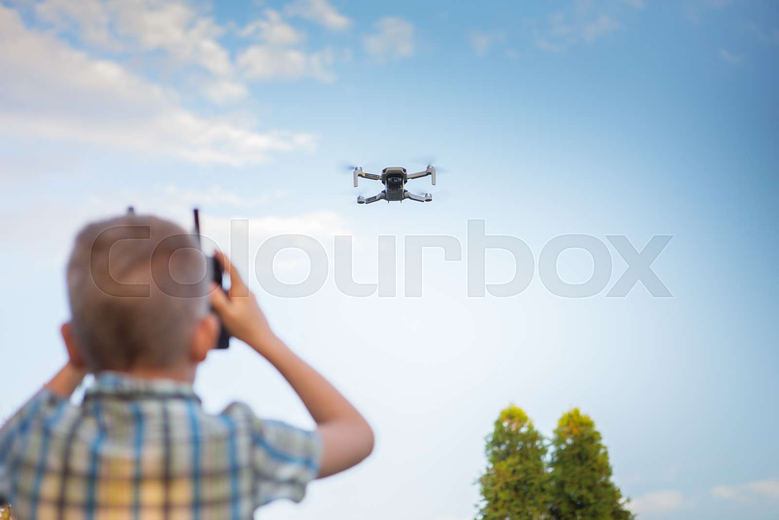 Kid flying drone. Boy operate drones | Stock image | Colourbox