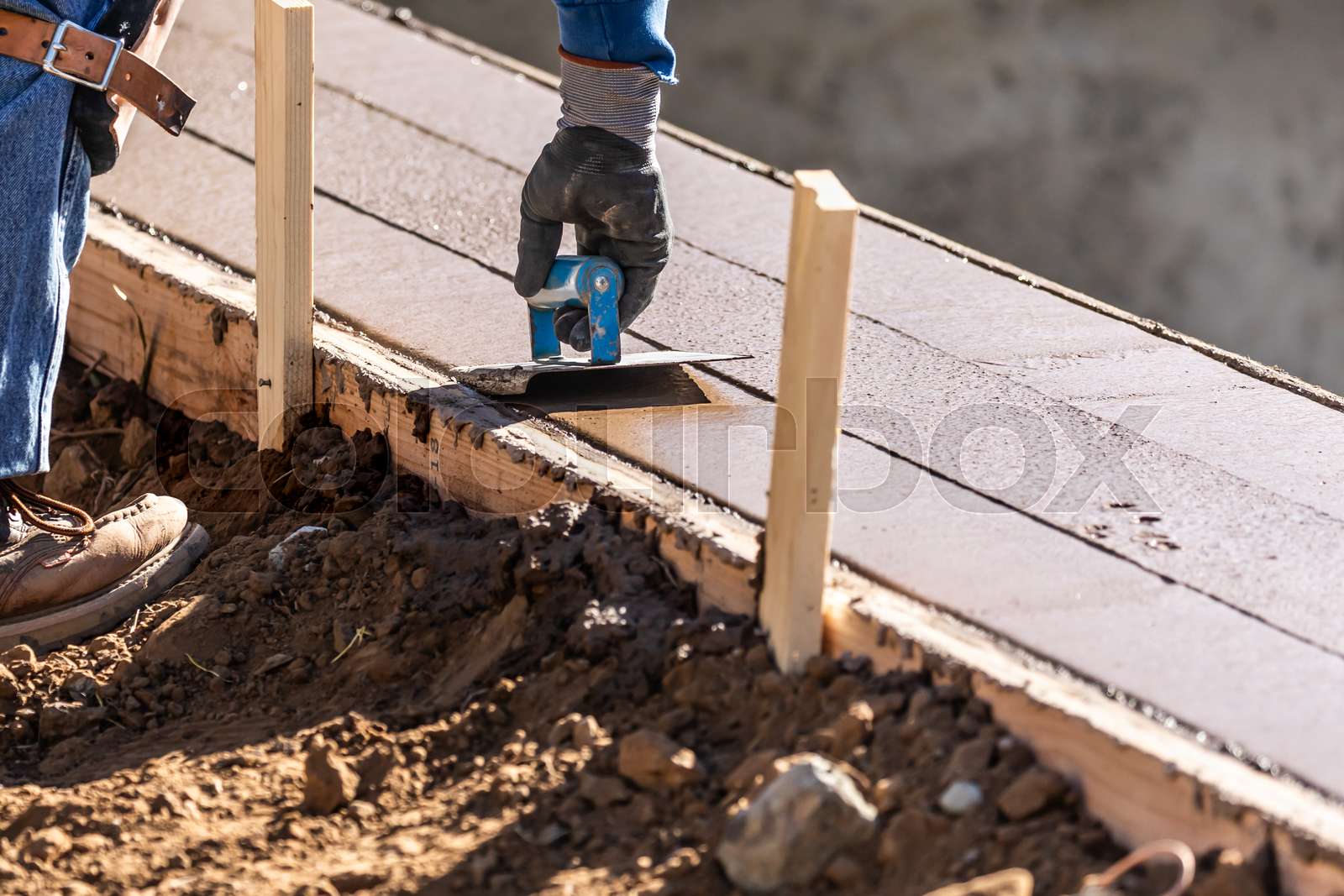 Construction Worker Using Hand Groover On Wet Cement Forming Coping ...