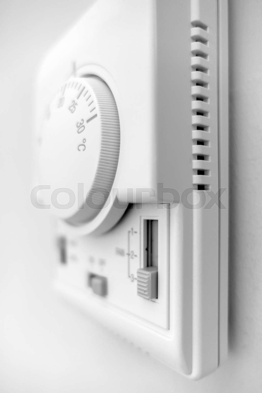Hand adjusting thermostat | Stock image | Colourbox