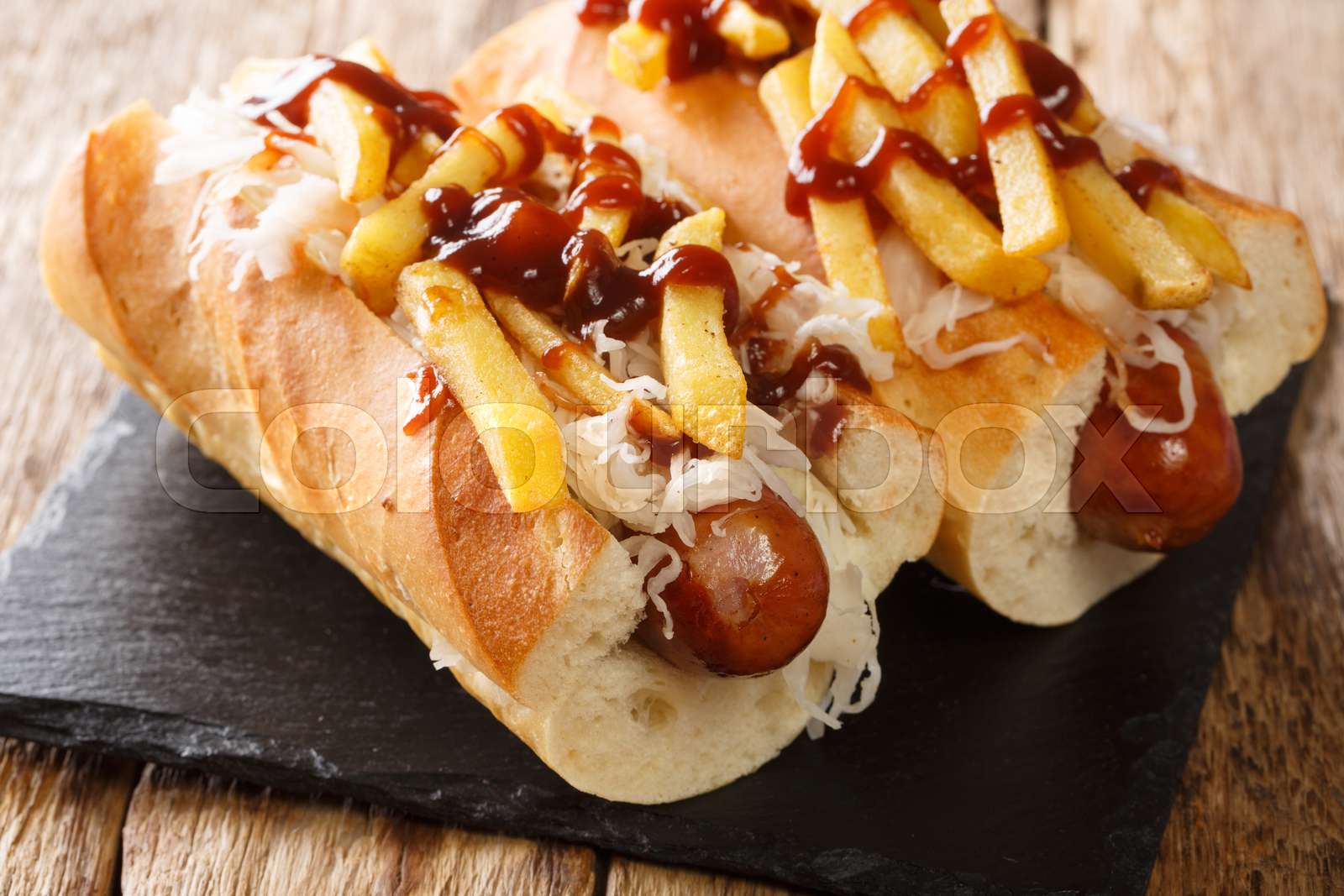 Delicious hot dog polish boy with sausage, cabbage, fries and barbecue ...