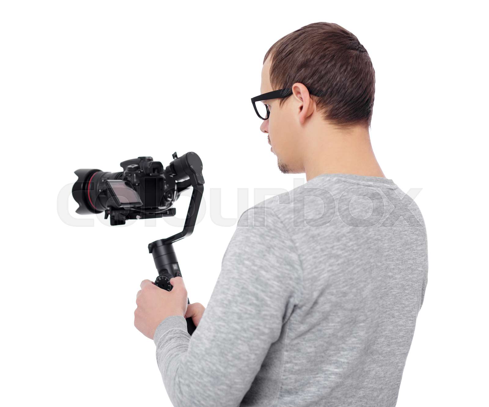 back view of professional videographer using dslr camera on gimbal ...