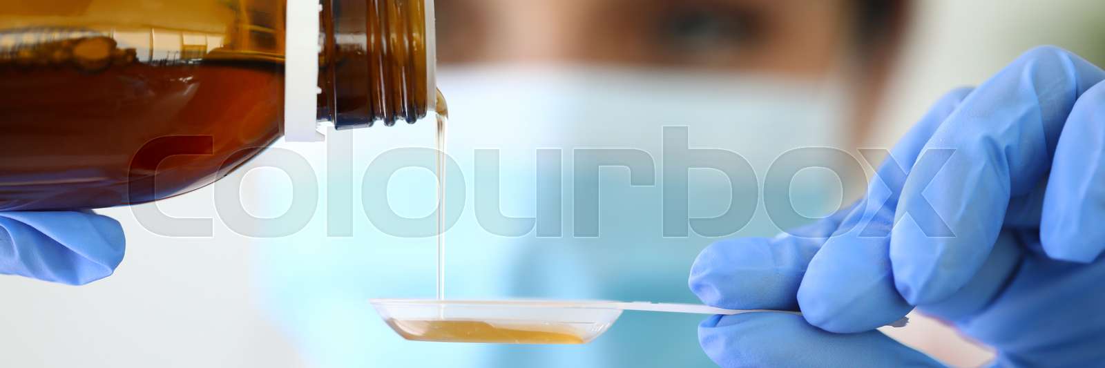 Nurse pouring medicated cold syrup into plastic spoon. | Stock image ...