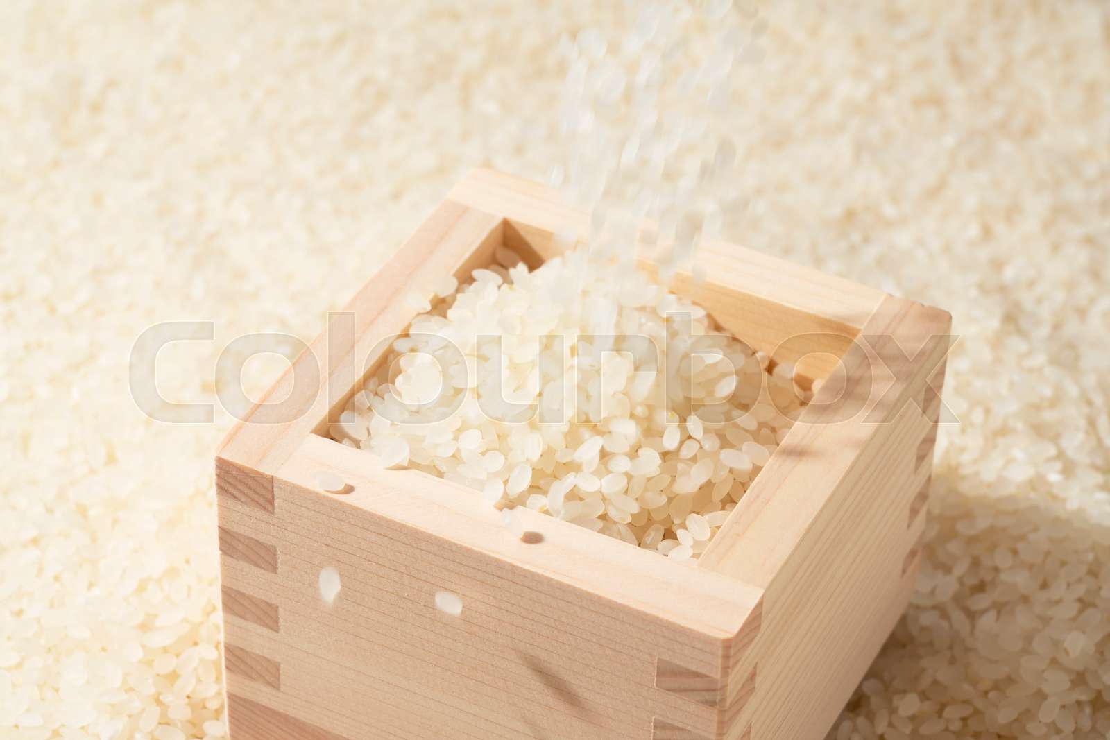 Dropping rice onto the white rice and squares laid out | Stock image ...