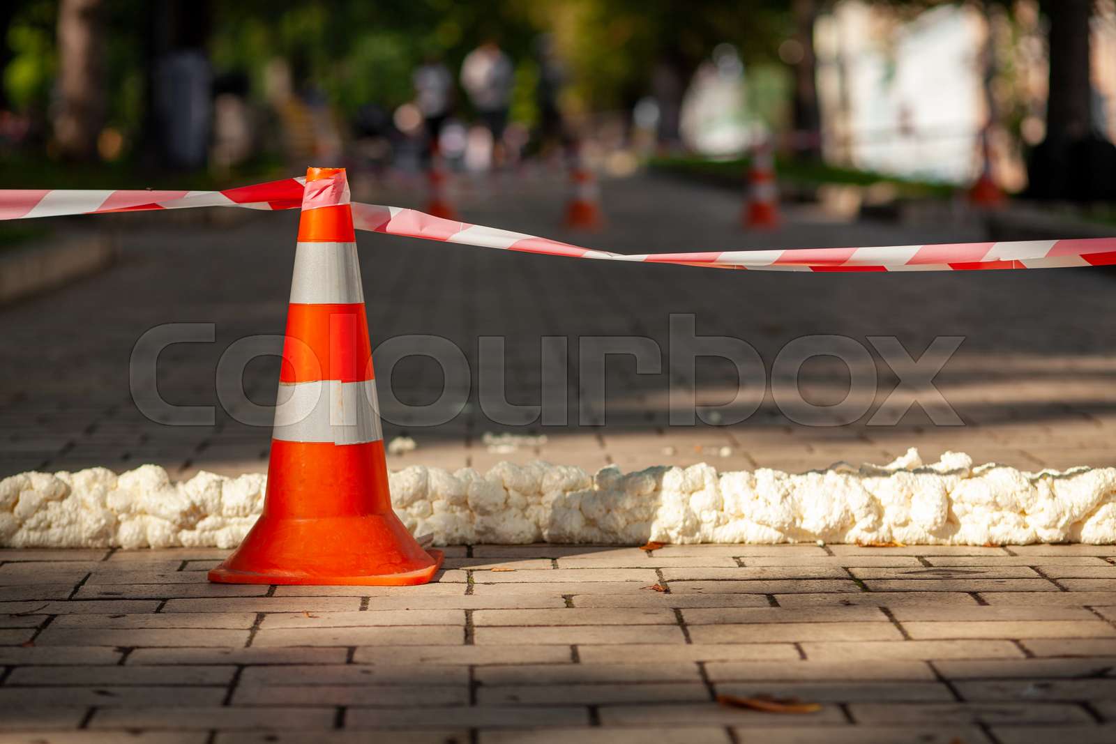 Traffic cone with caution tape. | Stock image | Colourbox