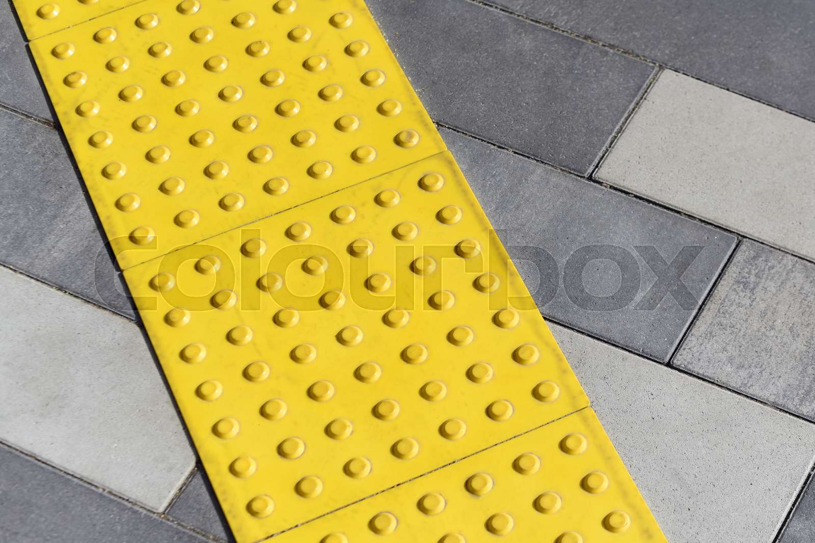 Yellow blocks of tactile paving for blind handicap. Braille blocks ...