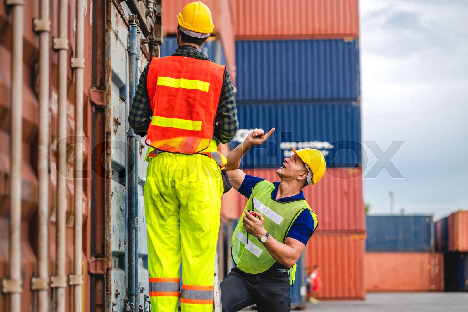 Professional of two engineer container cargo foreman in helmets working ...