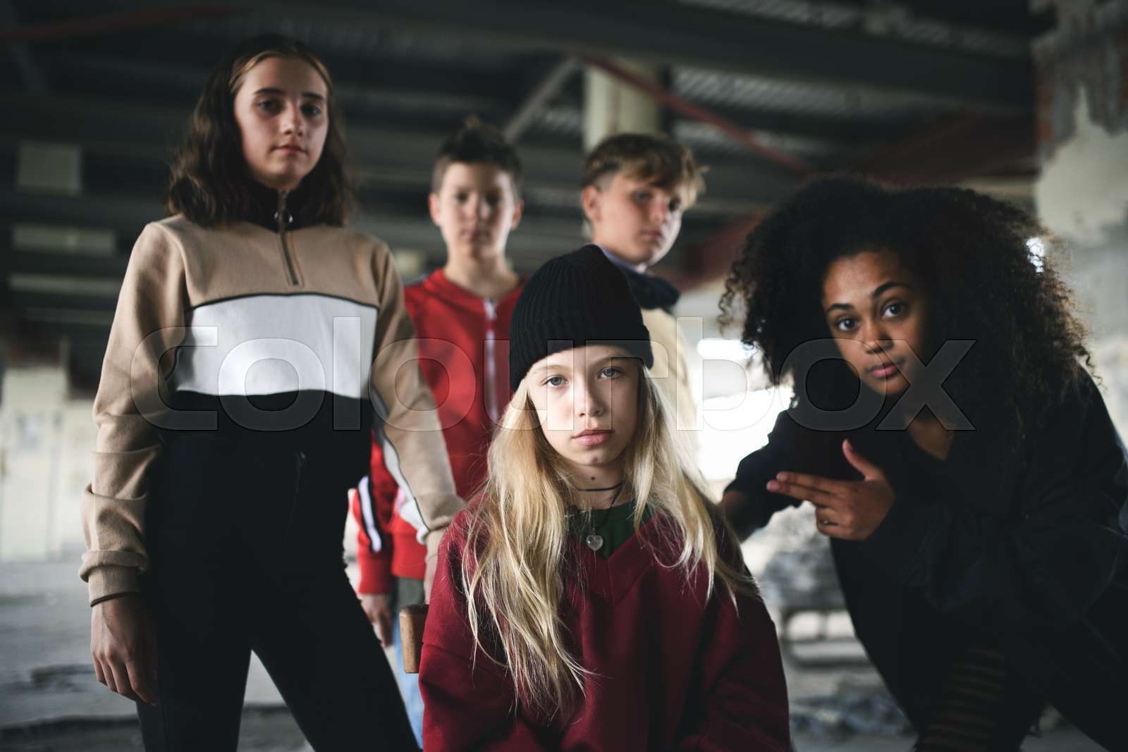 Group of teenagers gang standing indoors in abandoned building ...