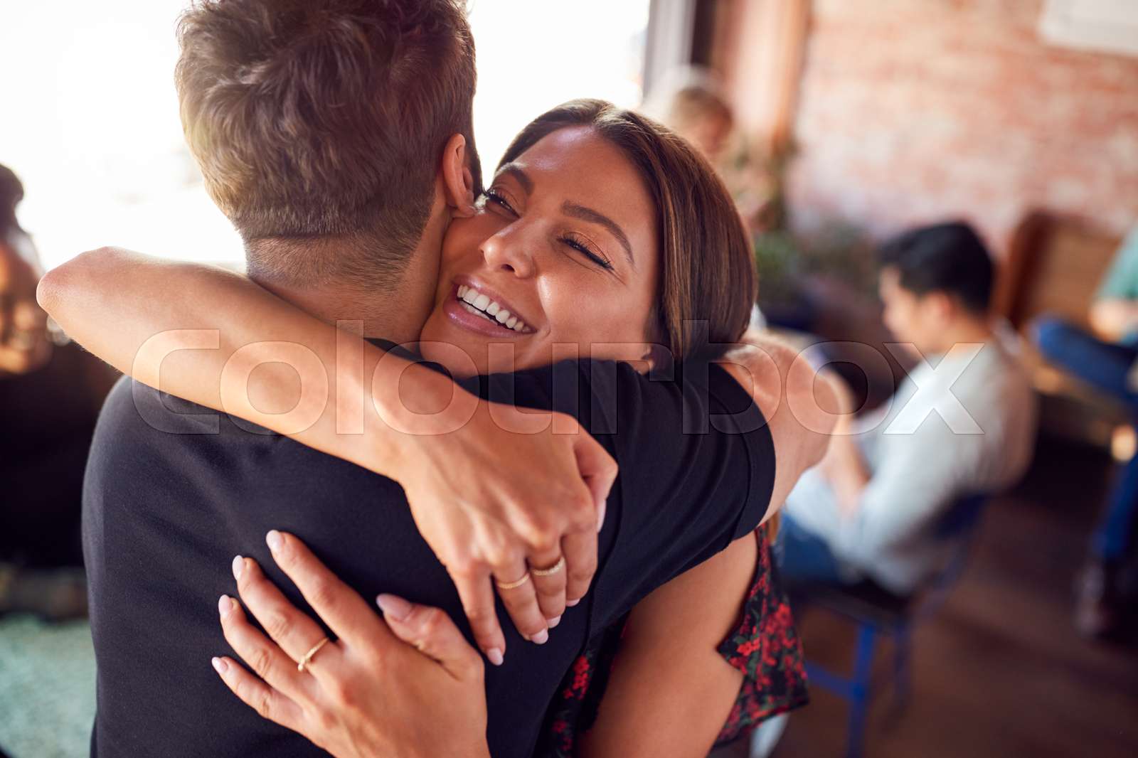 Couple Greeting Each Other With Hug As They Meet In Coffee Shop | Stock ...