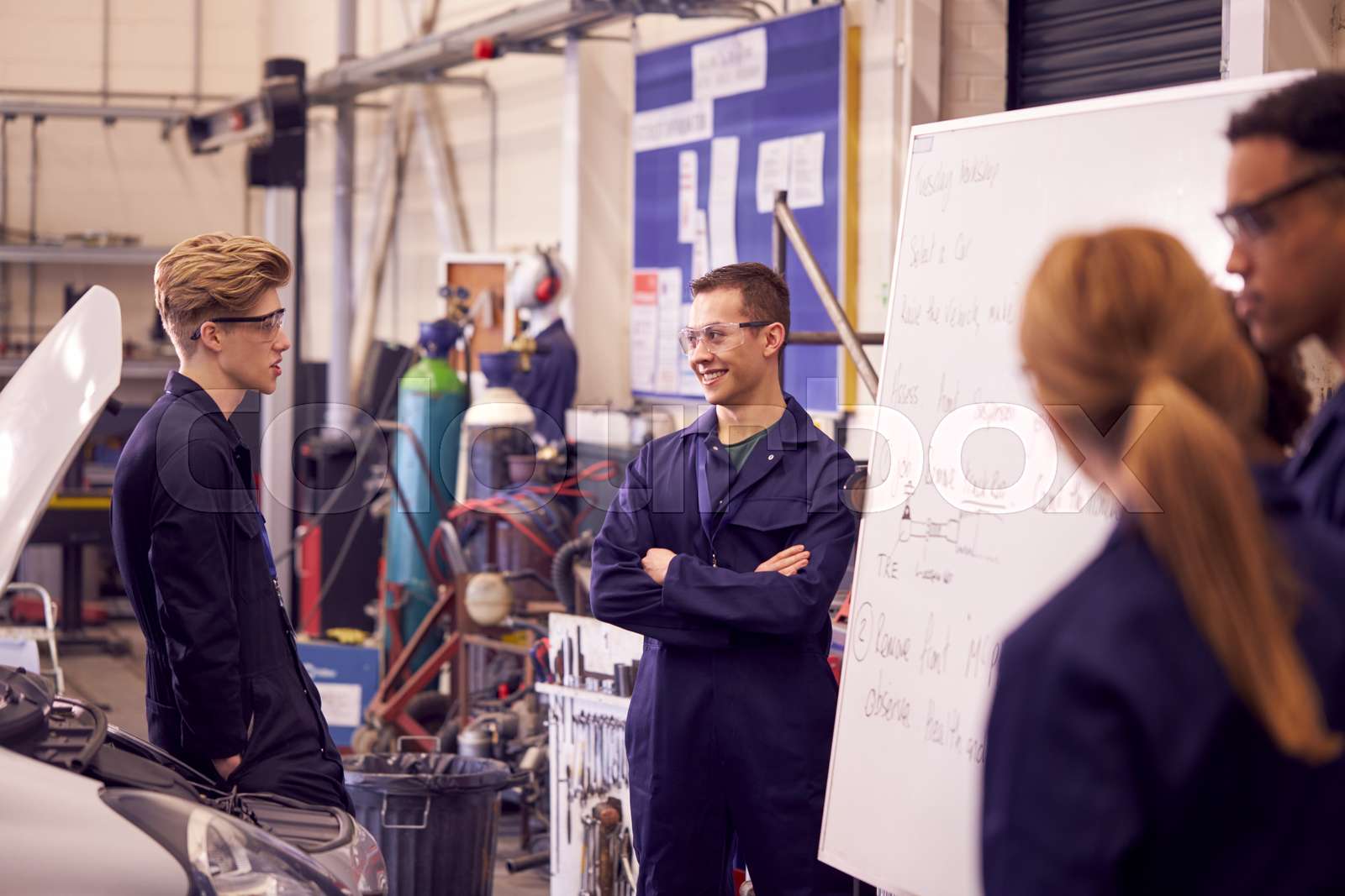 Students Studying For Auto Mechanic Apprenticeship At College Standing ...