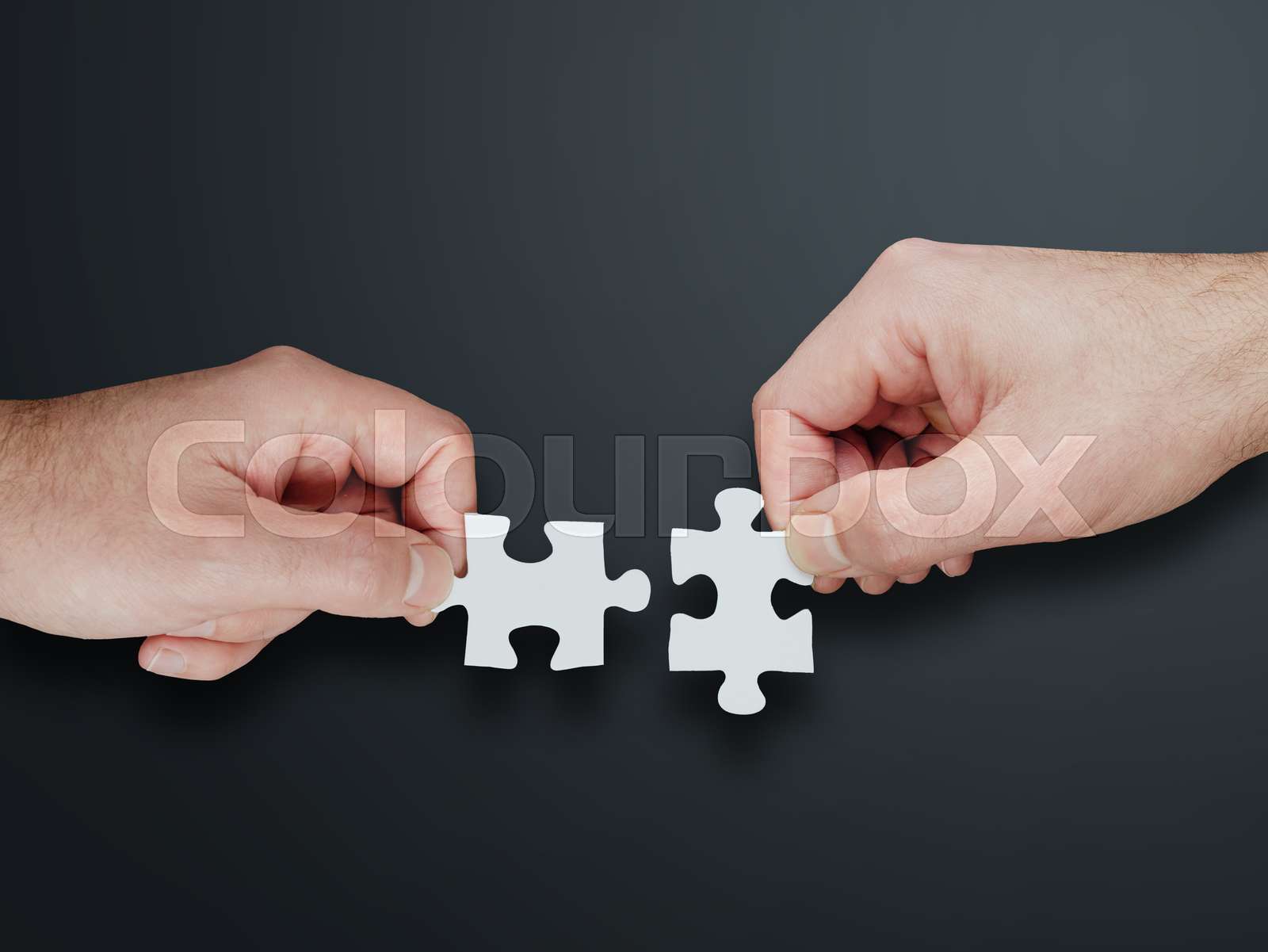 hands of two people putting together two jigsaw puzzle pieces | Stock ...