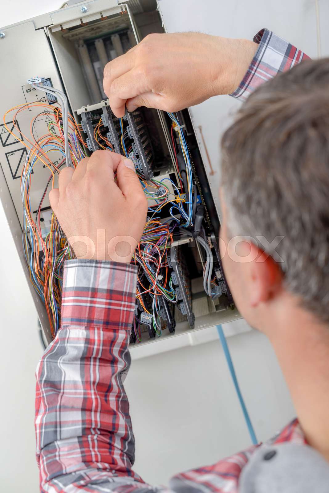 Electrician connecting wires in box | Stock image | Colourbox