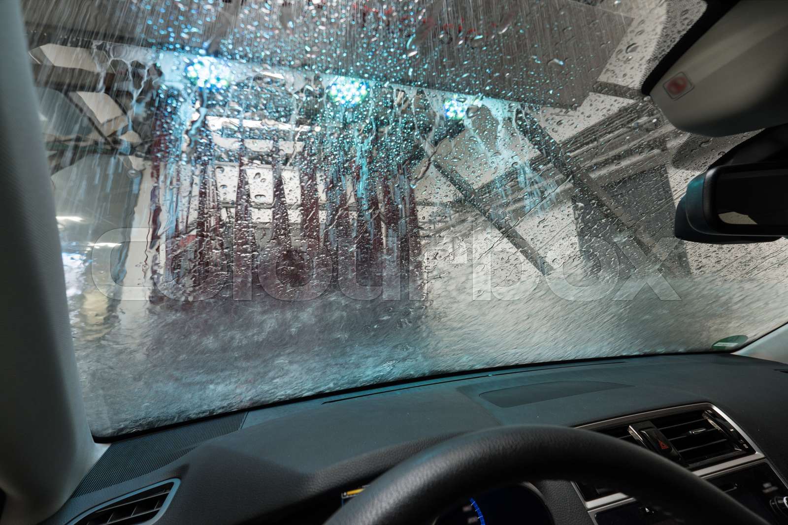 Automatic car wash with conveyor belt. A view from the car through the ...