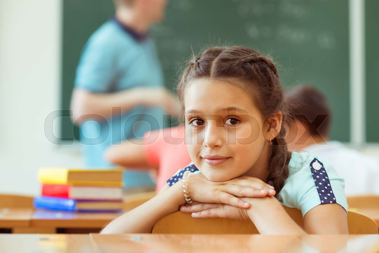 Cute smiling schoolgirl at school | Stock image | Colourbox