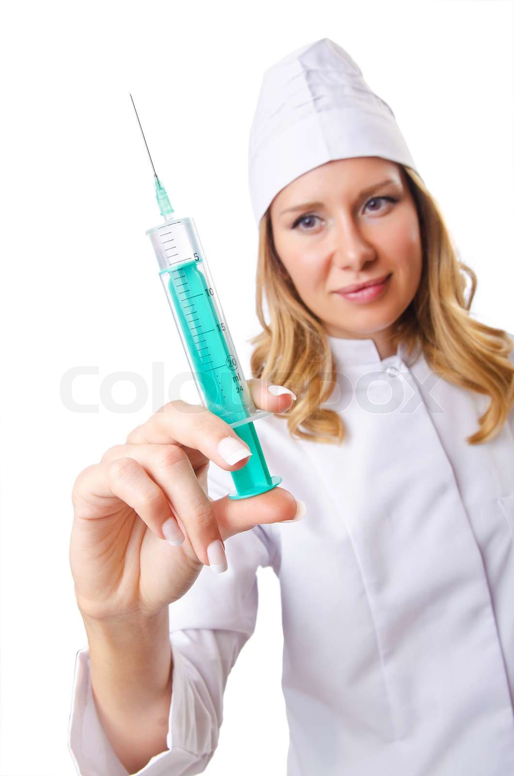 Woman doctor with syringe on white | Stock image | Colourbox