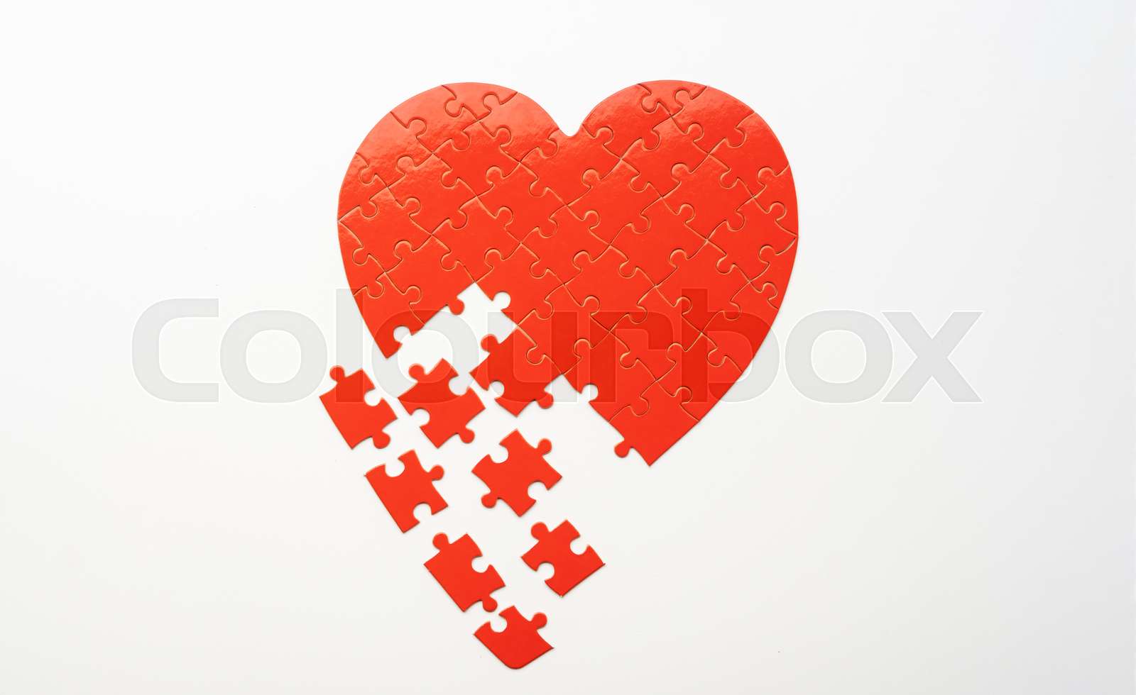 Heart shaped puzzle with scattered pieces | Stock image | Colourbox