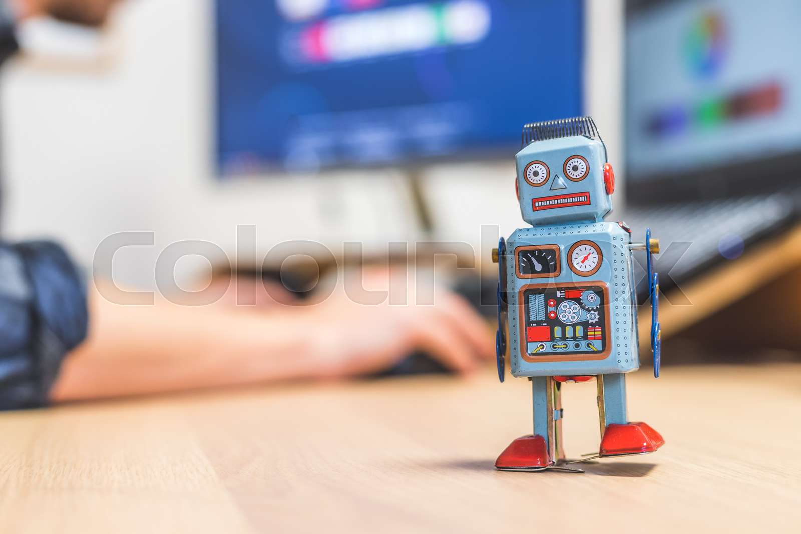 Artificial intelligence concept: Toy robot on office desktop. Metaphor ...