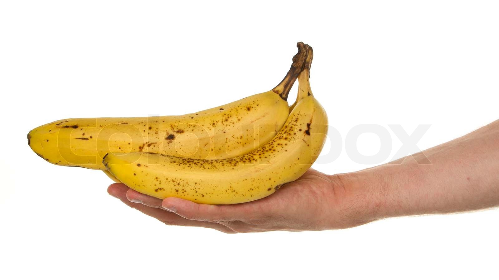 Hand full of bananas | Stock image | Colourbox