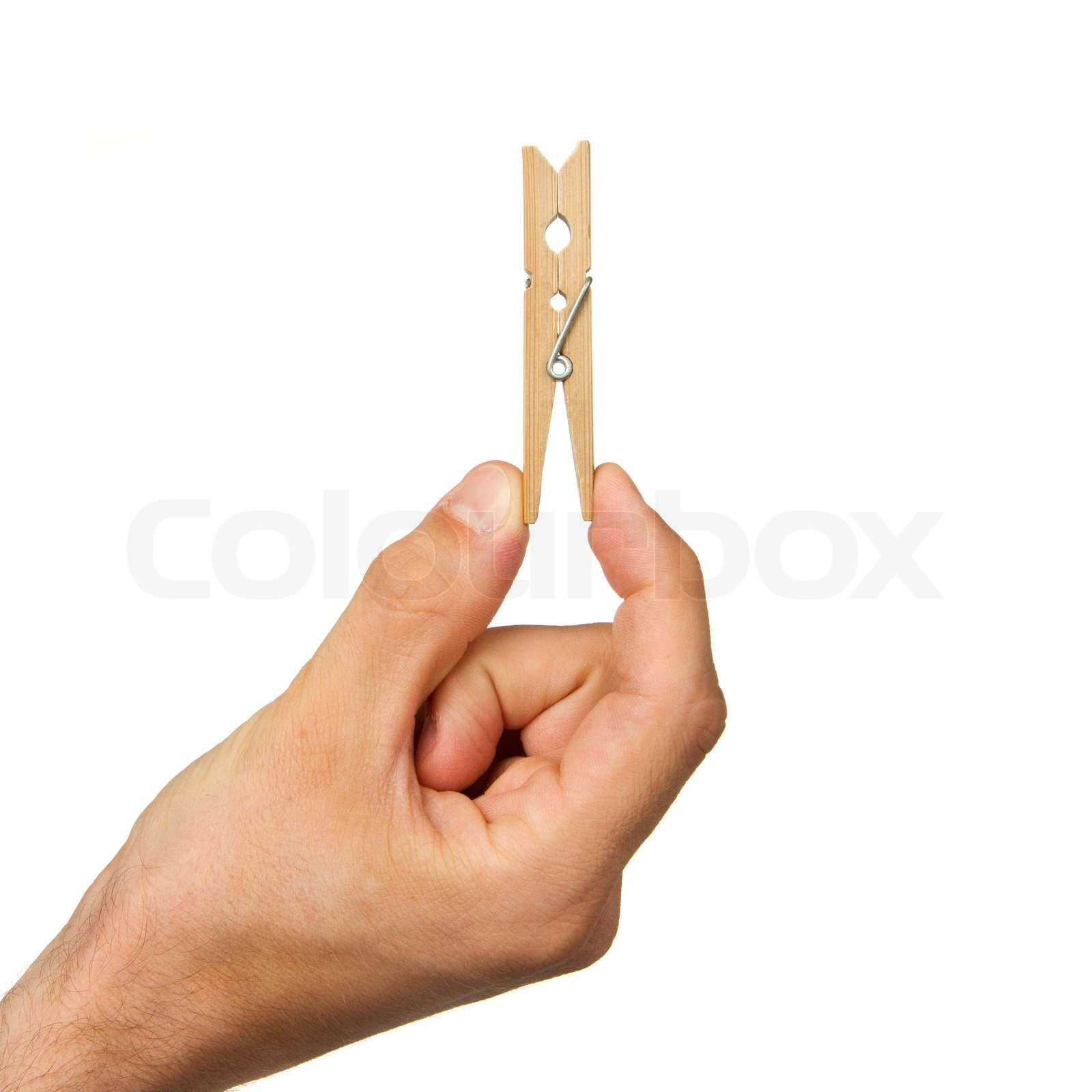 Hand holding clothes peg | Stock image | Colourbox