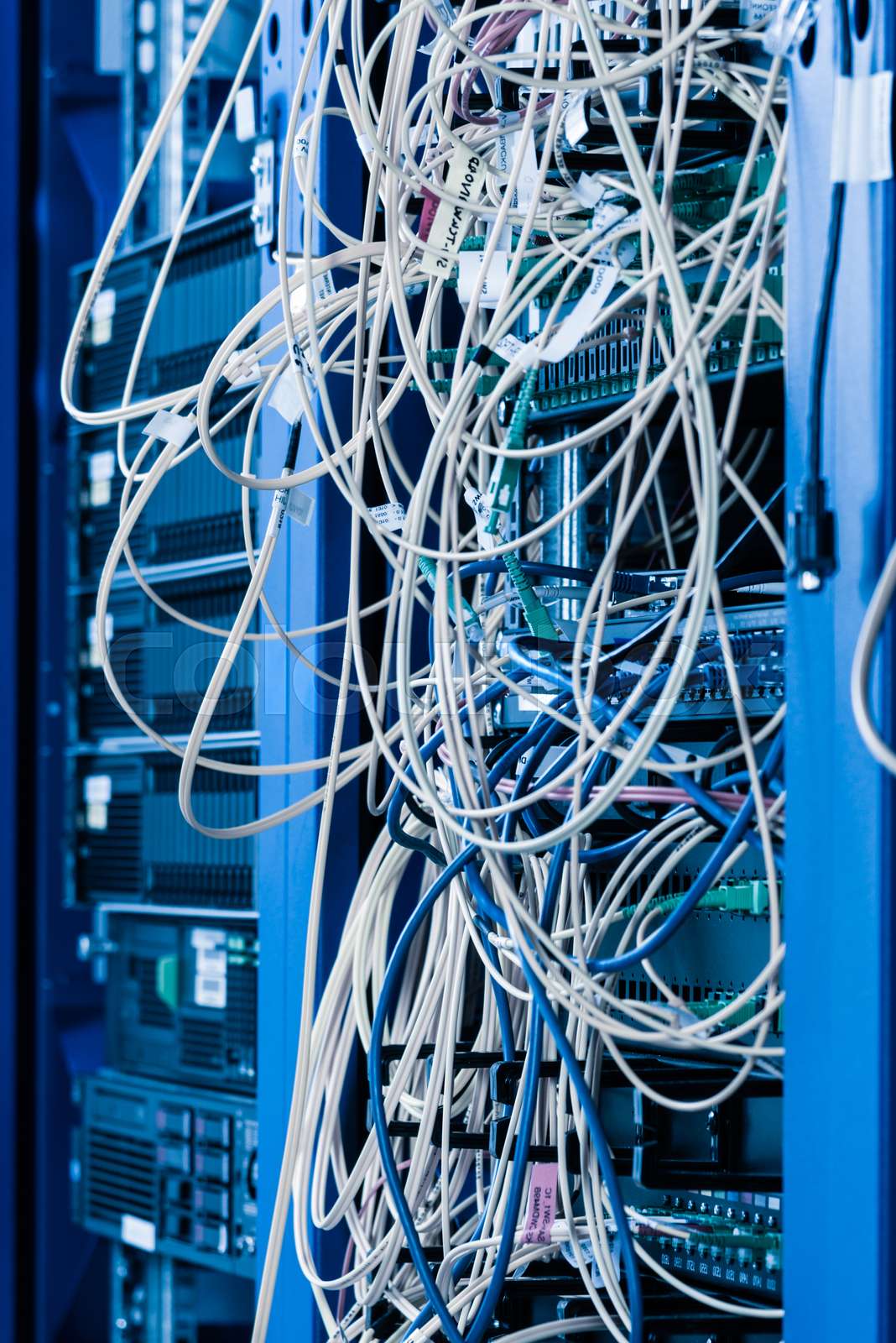 Server rack with fiber optic cables attached to front panel swit ...