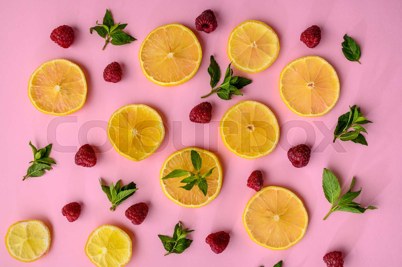Lemon slices and strawberries on purple background - Stock Image ...