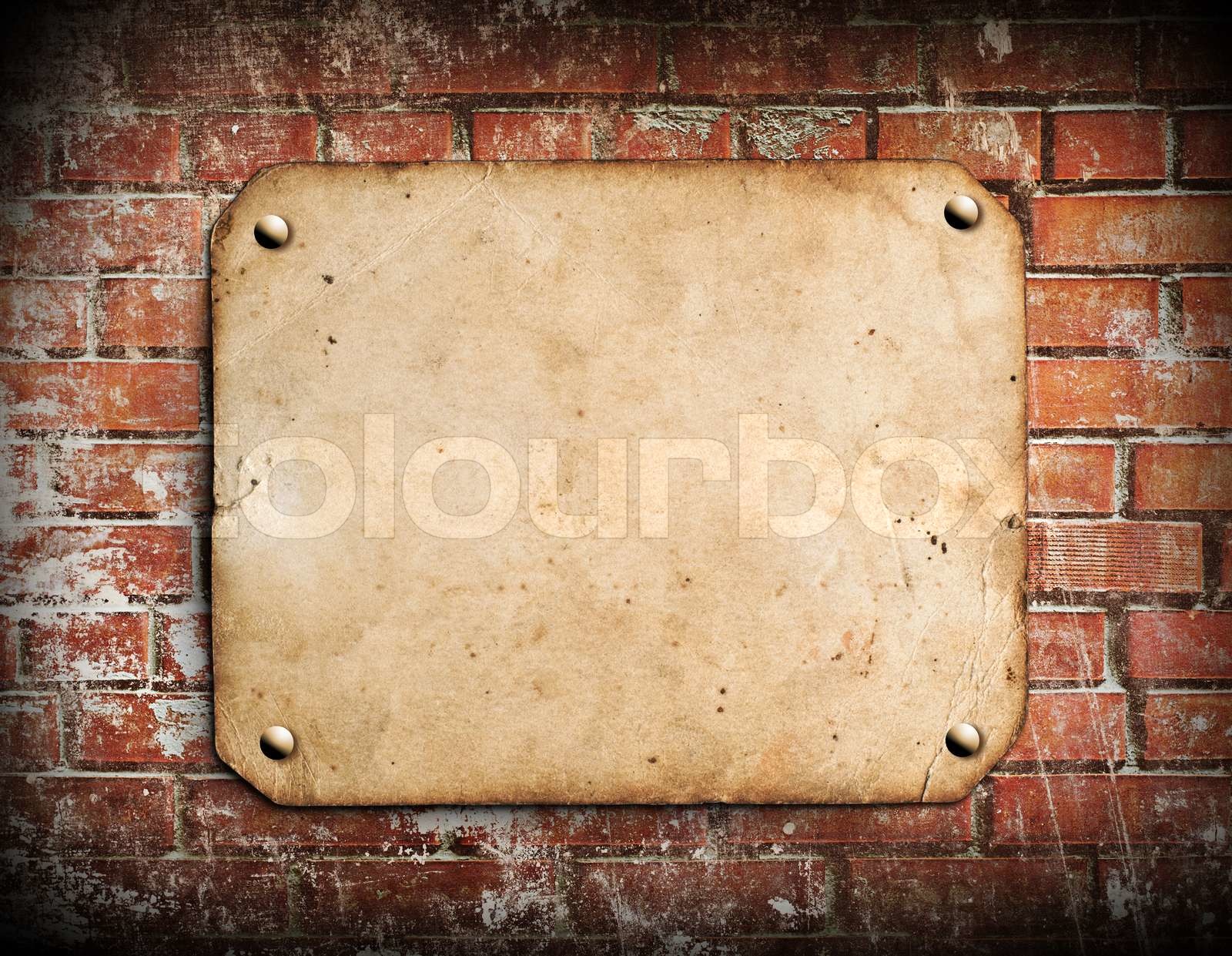 Old paper on brick wall | Stock image | Colourbox
