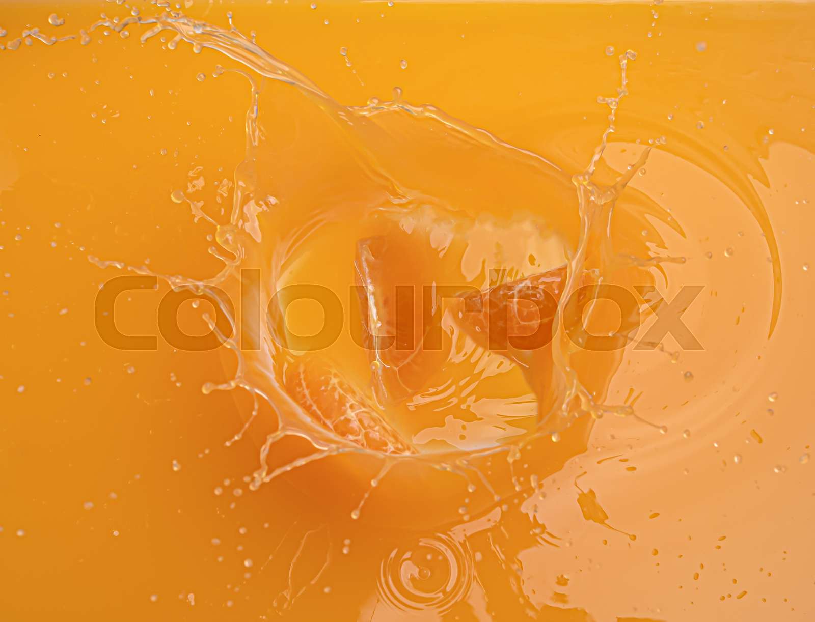 Falling of orange piece into juice,splash orange juice | Stock image ...