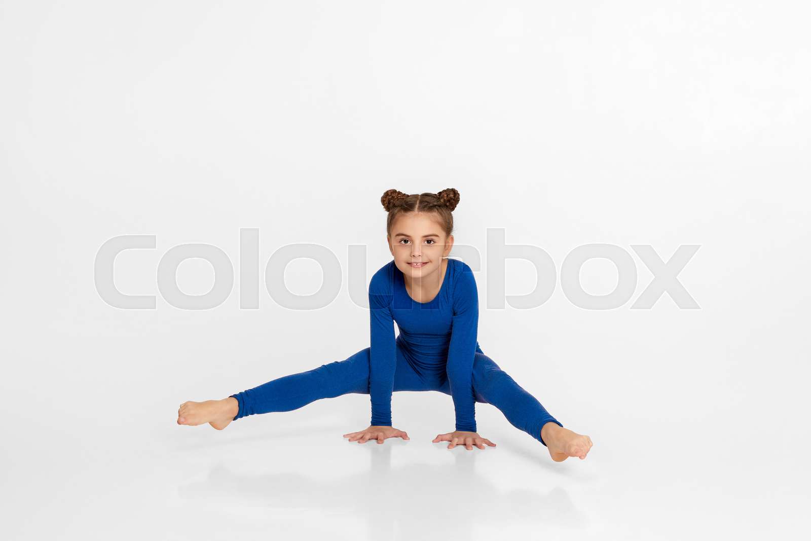 child girl in sportswear performs a handstand. | Stock image | Colourbox