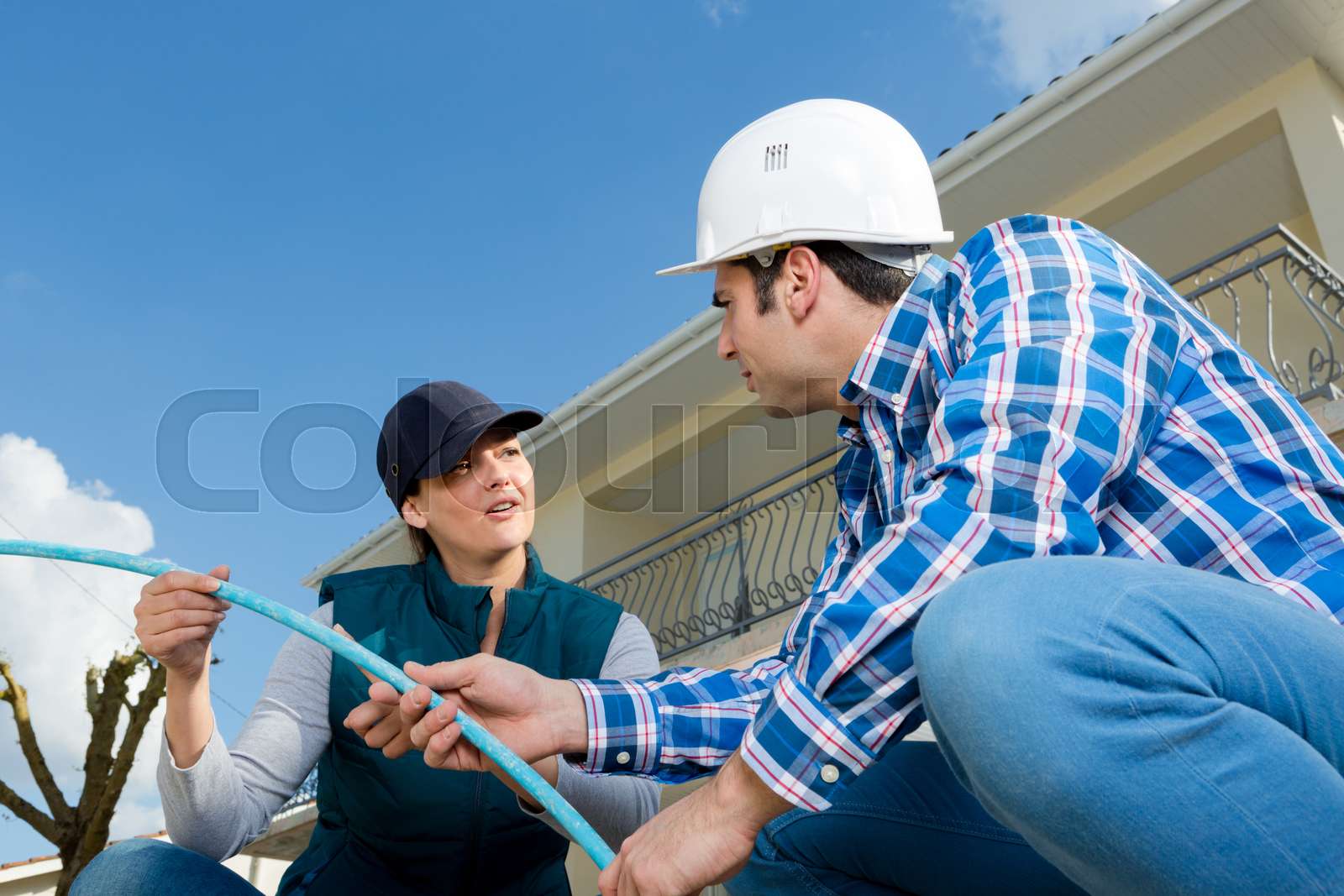 workers plumber fixing sewerage pipe at construction site | Stock image ...