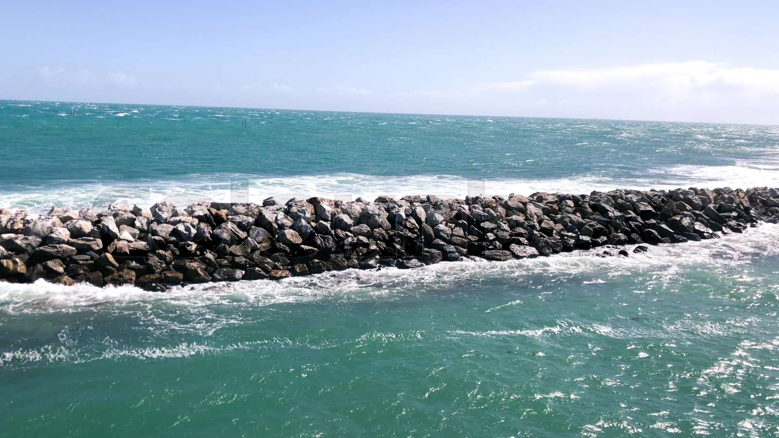 Aligned rocks along the shoreline, sea barrier | Stock video | Colourbox