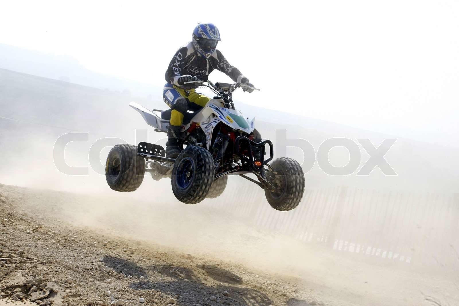 quad racer jumping on a track | Stock image | Colourbox