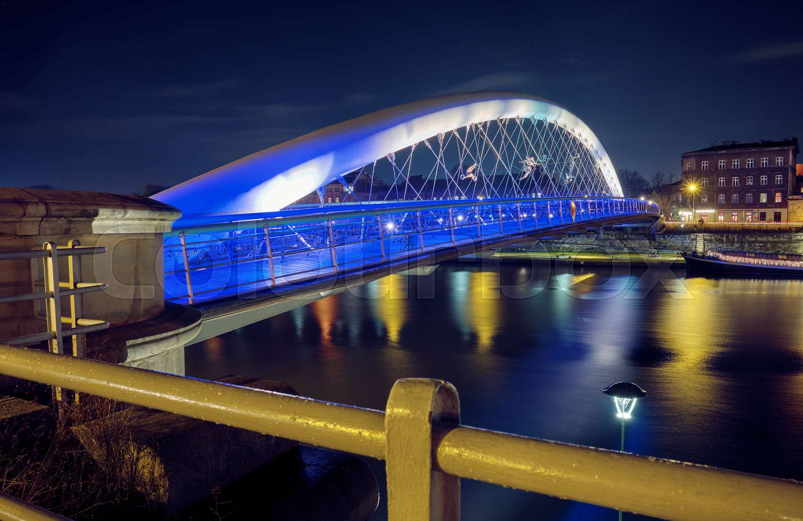 Father Bernatek's Bridge in Krakow at night. | Stock image | Colourbox
