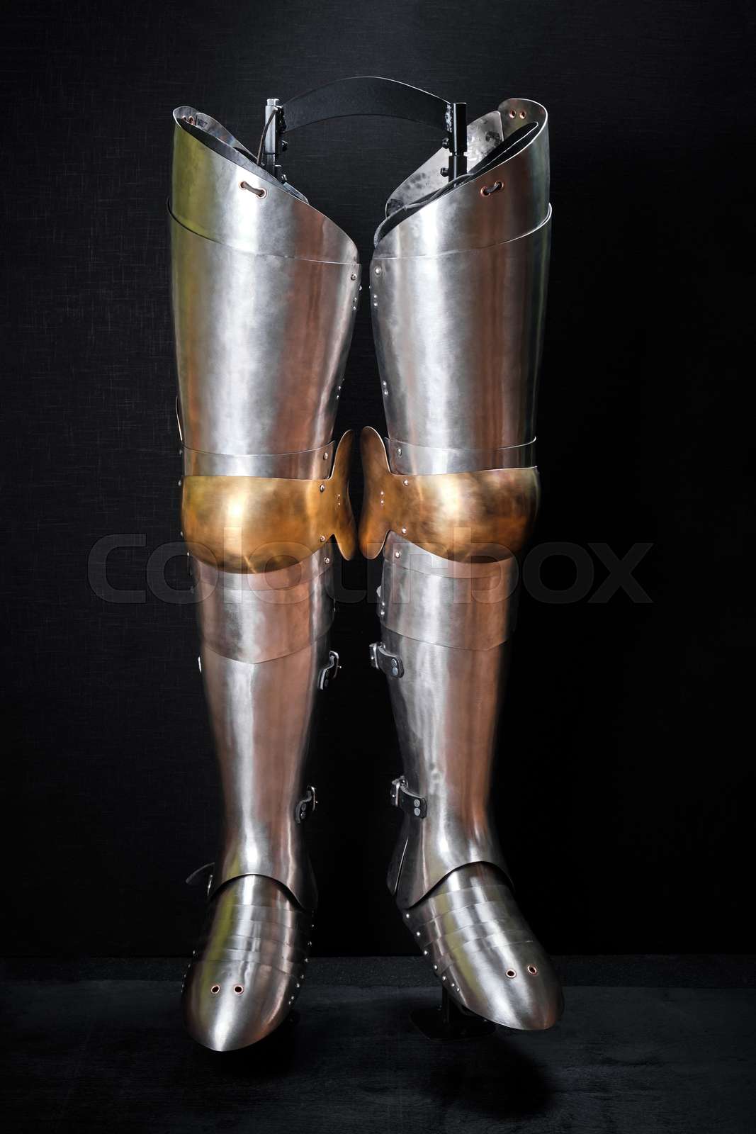 Real knight armor for legs on a black. | Stock image | Colourbox
