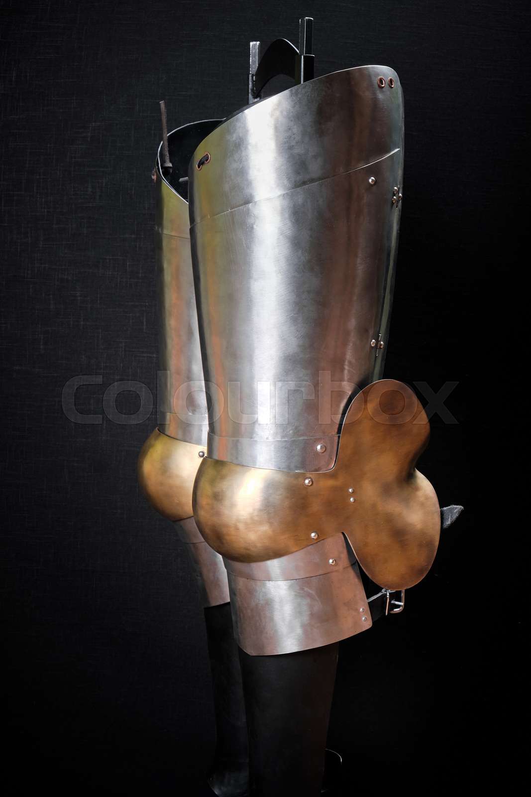 Real knight armor for the thigh on a black | Stock image | Colourbox