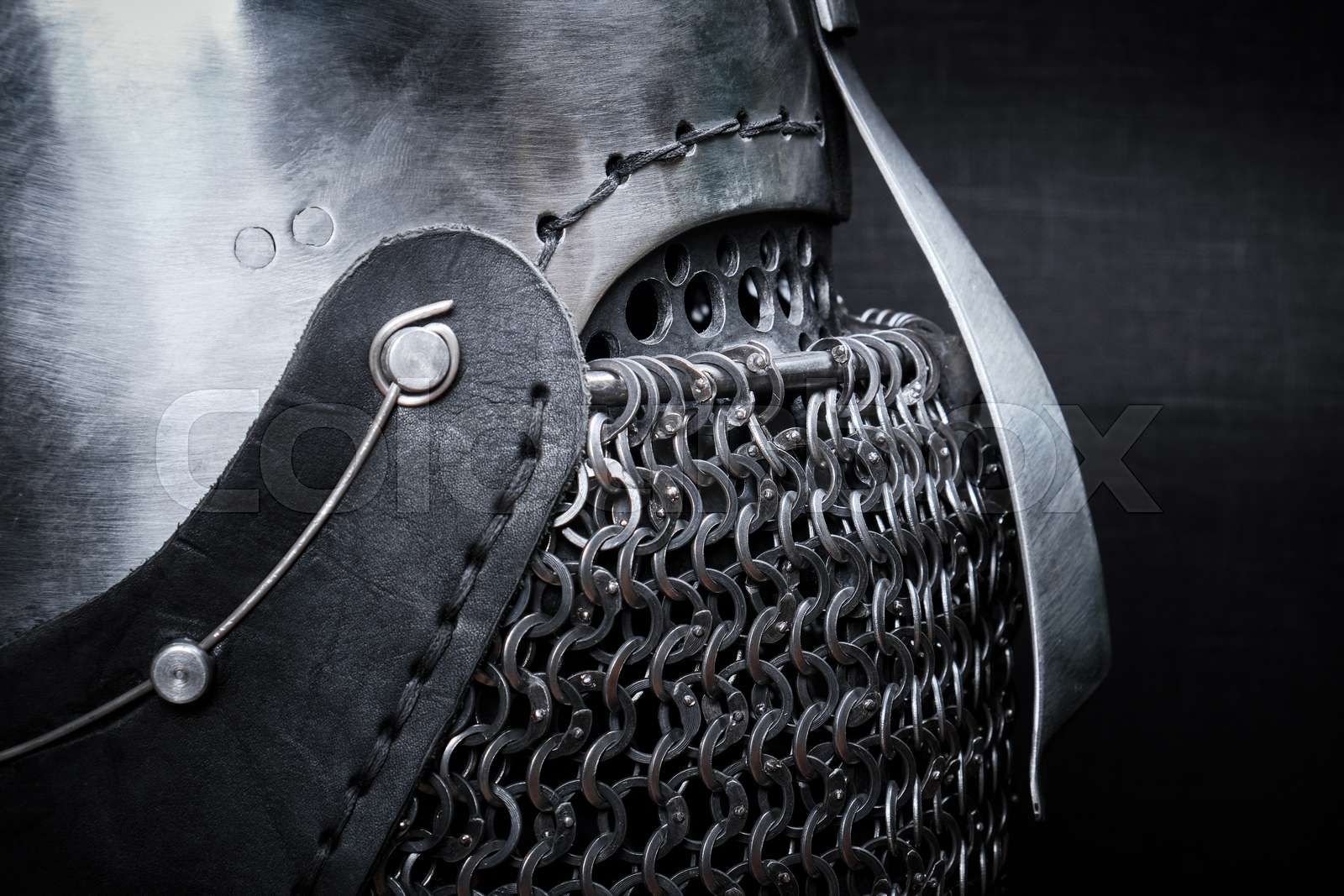 Knight's helmet close-up side view on a black. | Stock image | Colourbox