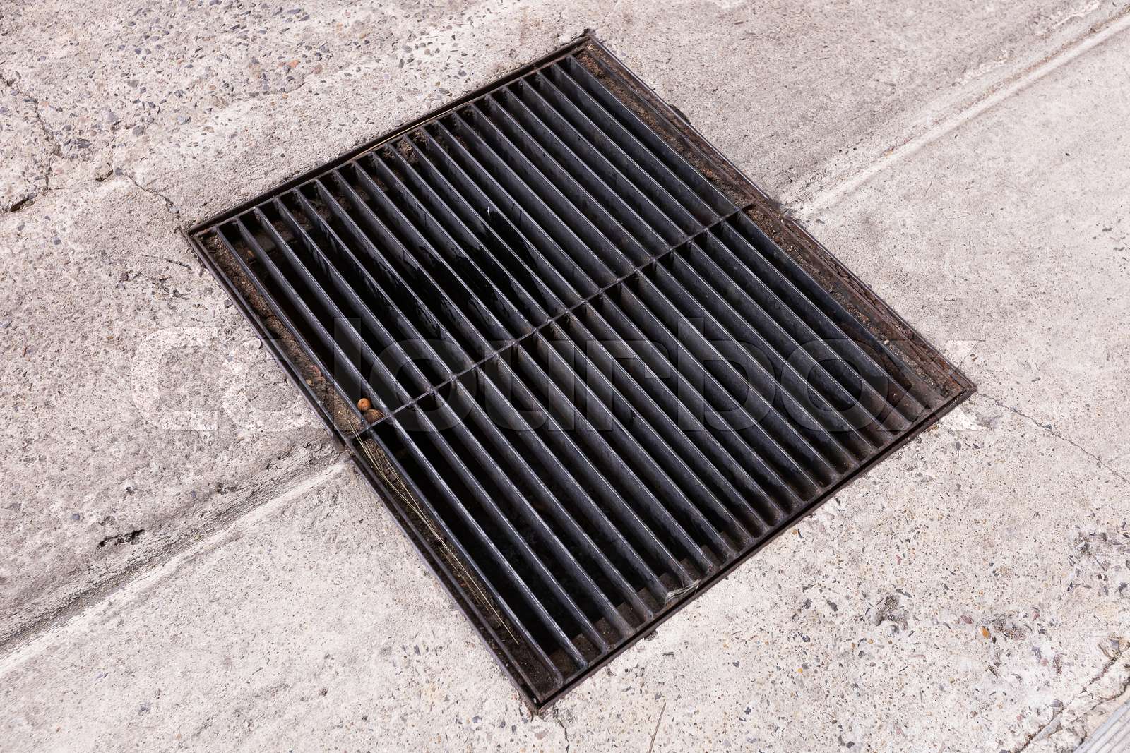 Old steel drainage grating on road | Stock image | Colourbox