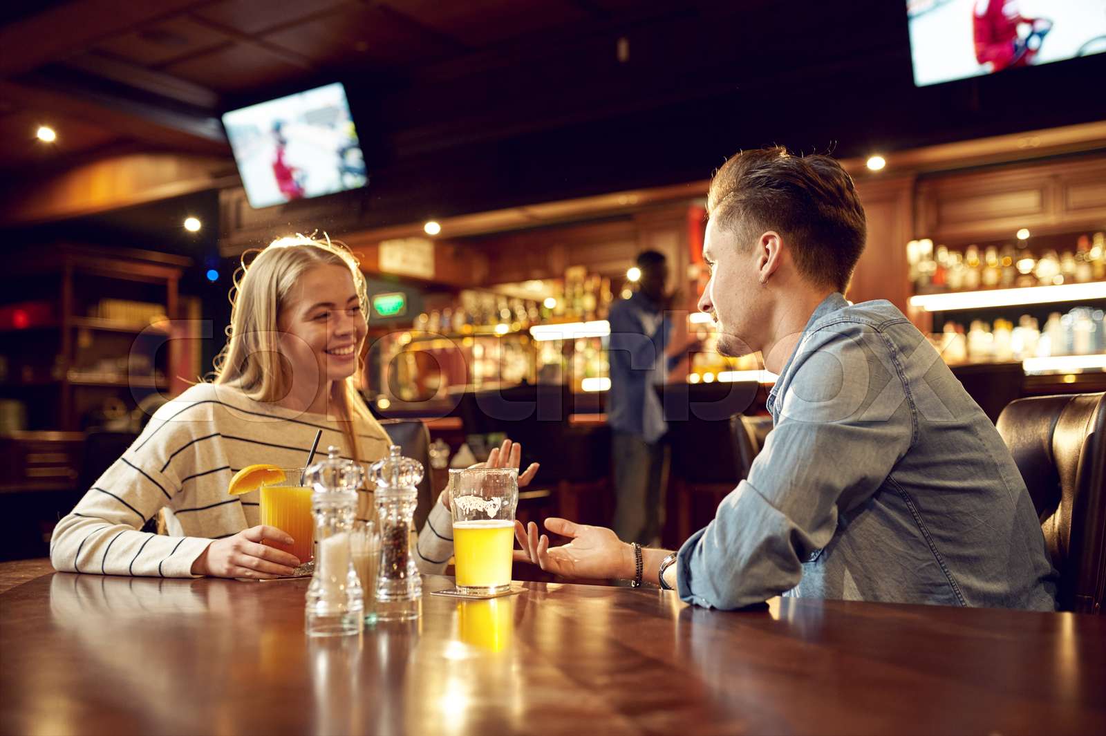 Man and woman drinks alcohol and talking in bar | Stock image | Colourbox