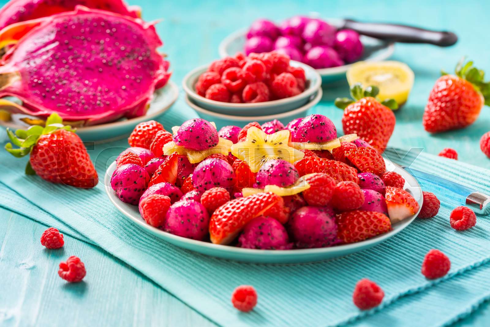Fresh dragon fruit salad with strawberries, raspberries and start fruit ...