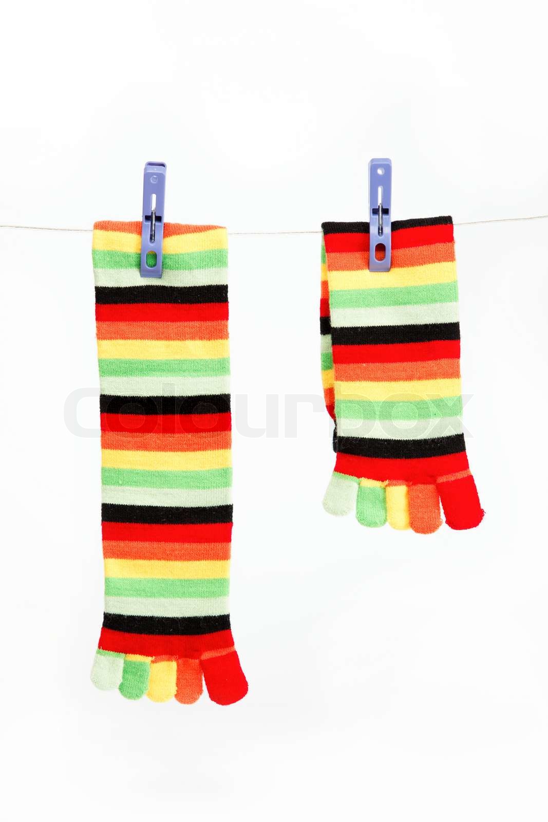 Colorful fun socks attached clothespin hanging from a rope | Stock ...