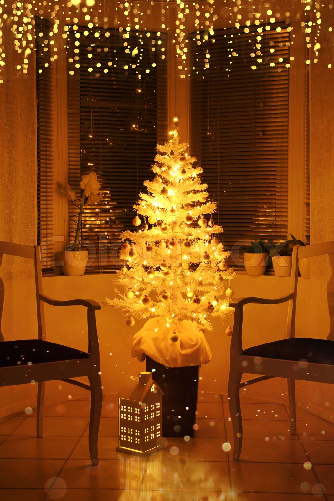 Illuminated white Christmas tree in front of a bay window | Stock image ...
