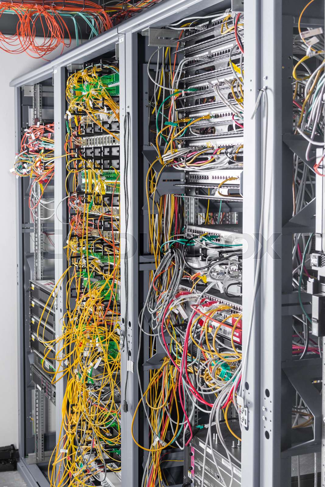 Server rack with fiber optic cables attached to front panel swit ...