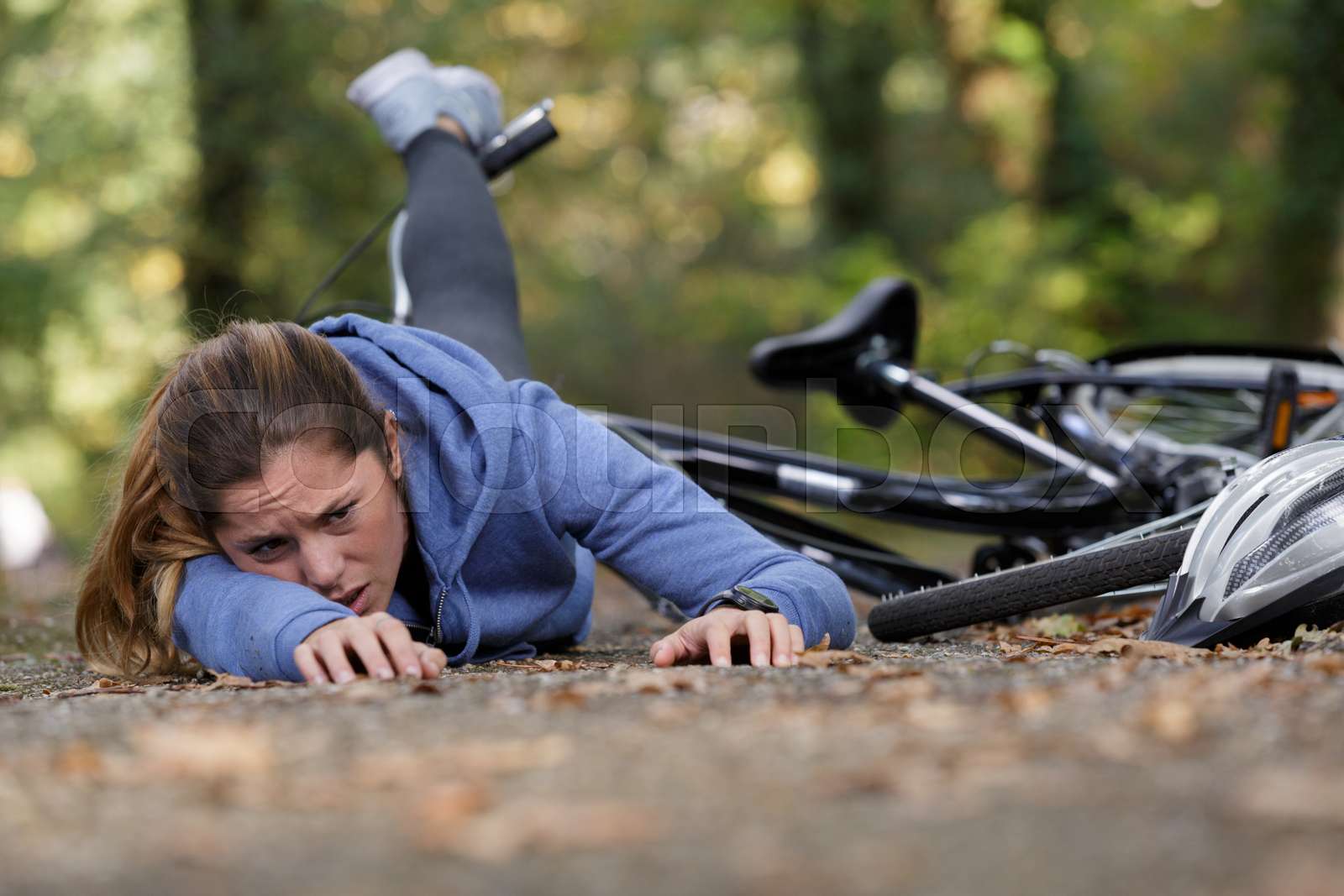 female biker fell off her bike | Stock image | Colourbox