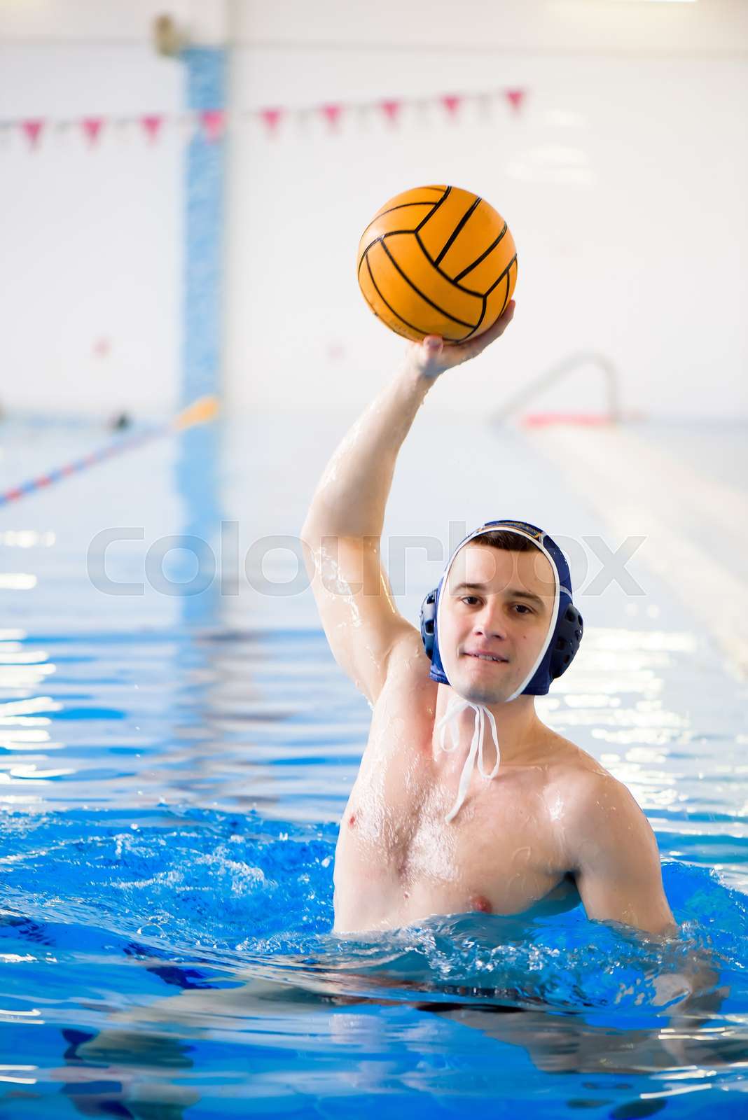 Water polo training. Young sportsman plays water polo in the pool ...