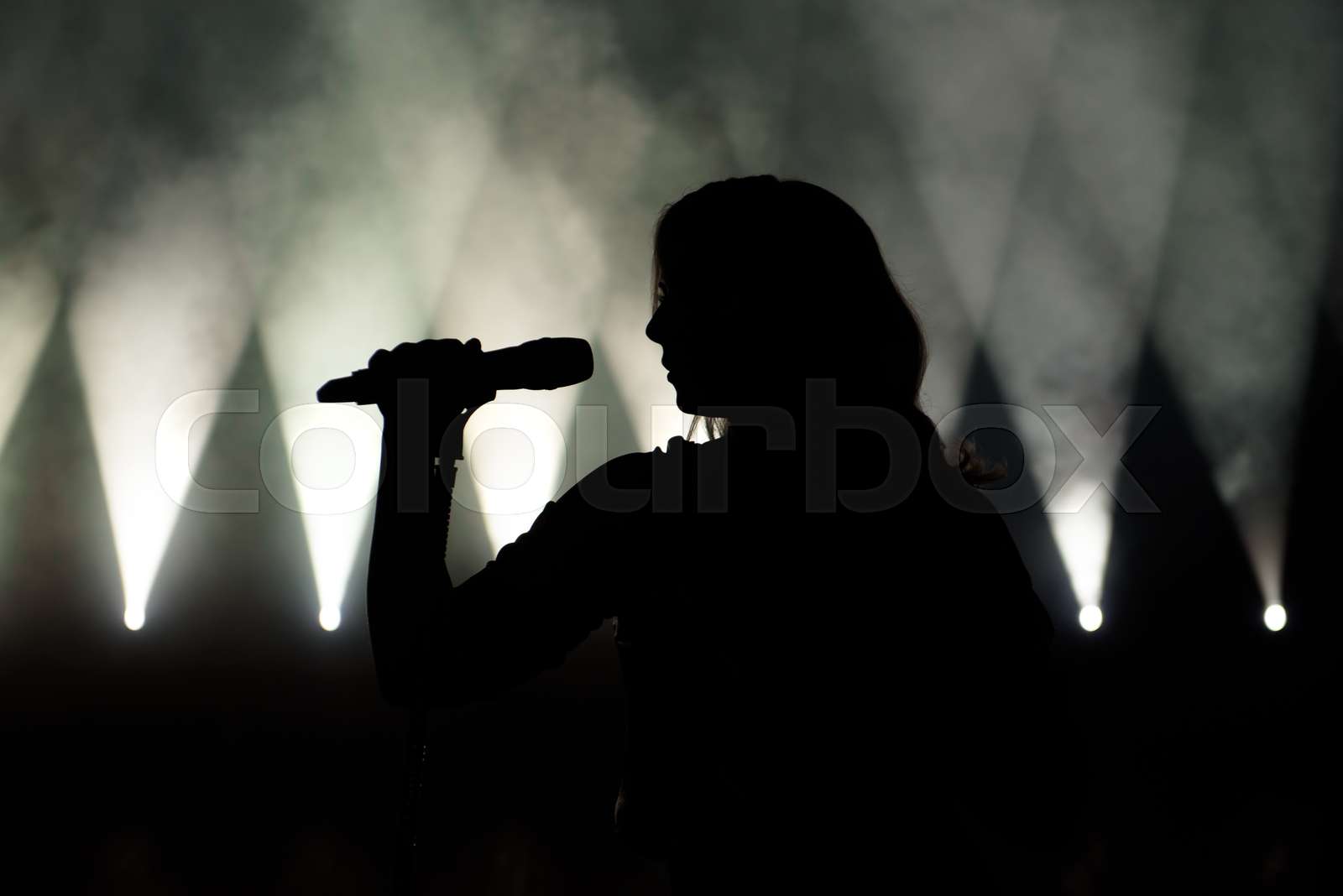 Singer in silhouette. Close up image of live singer on stage | Stock ...