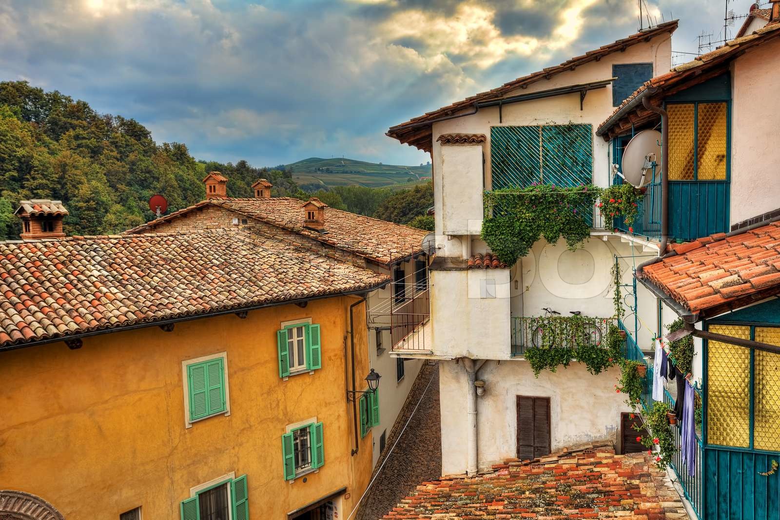 Fragment of small italian town with colorful houses, roofs covered by ...