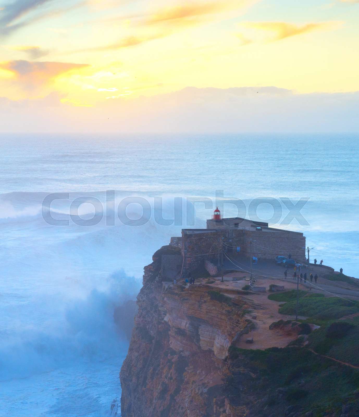Lighthouse Nazare Portugal surfing waves | Stock image | Colourbox