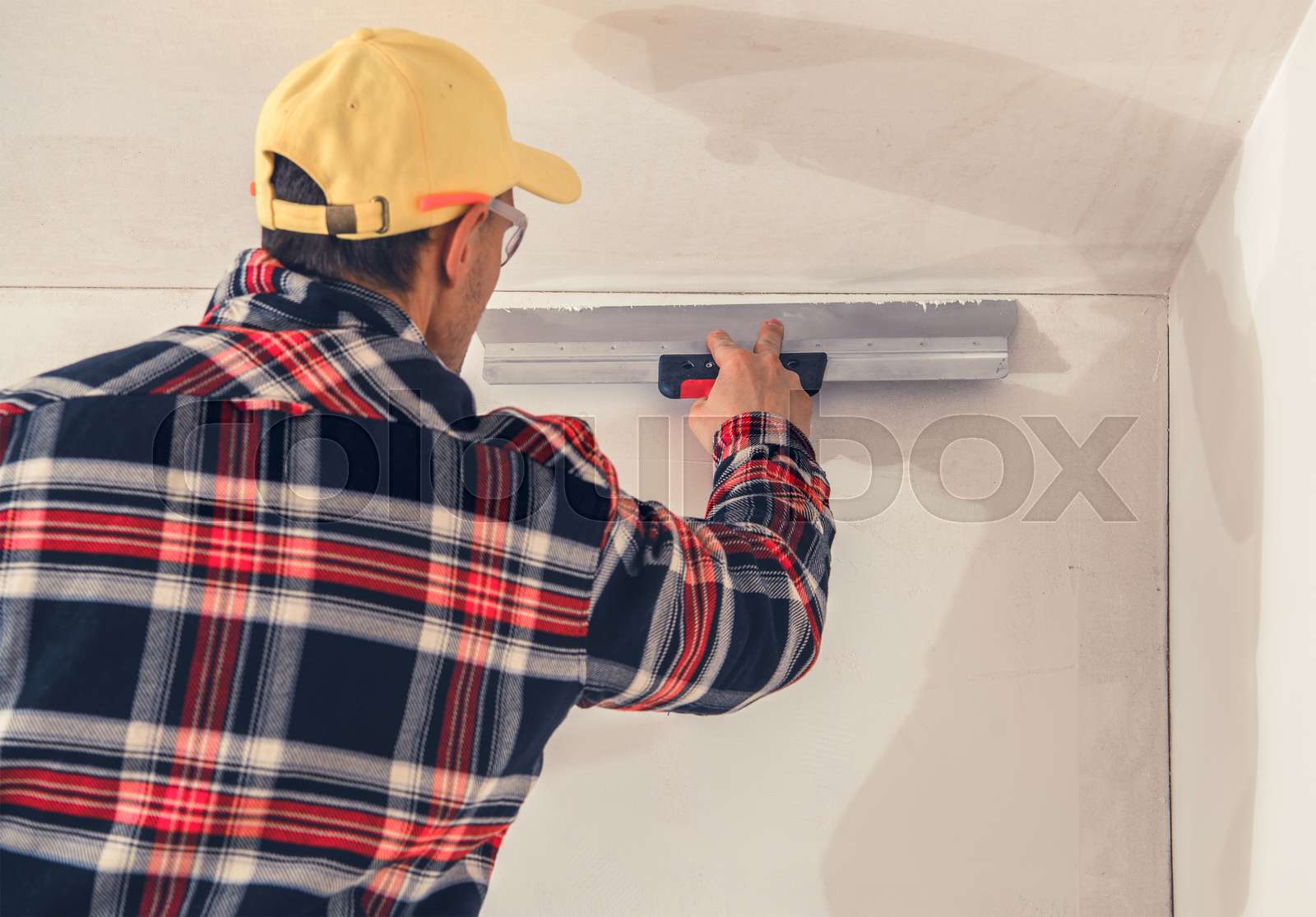 Construction Finishing Worker Patching Drywall | Stock image | Colourbox