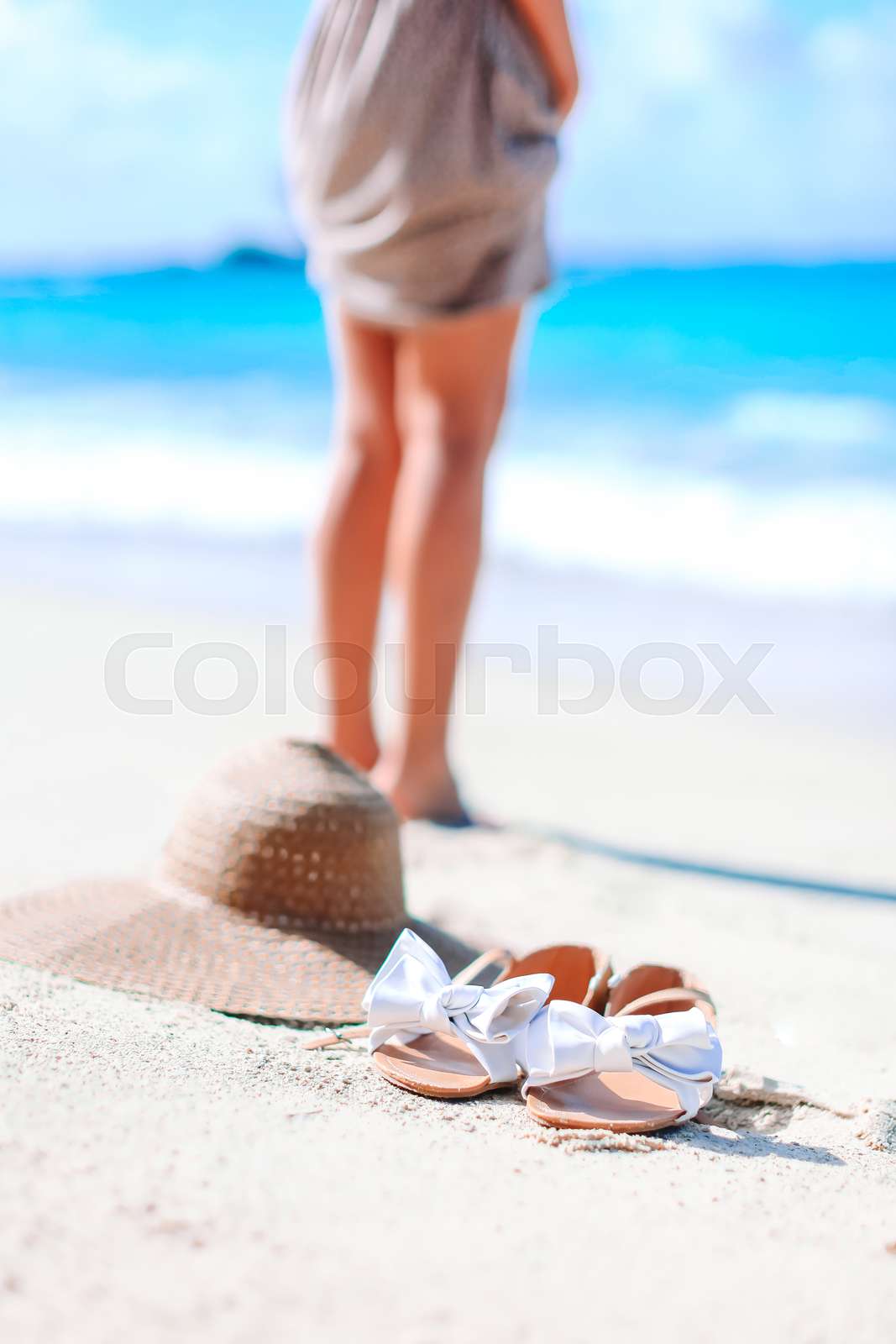 Young woman sunbathing on white beach. Legs. | Stock image | Colourbox