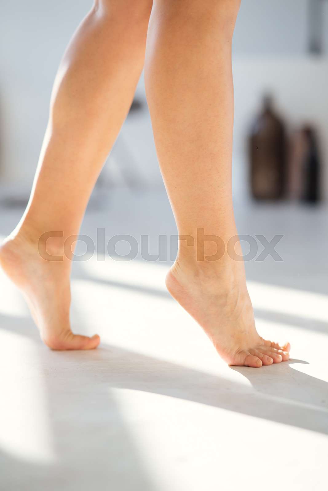 Female feet walking on floor close up view | Stock image | Colourbox
